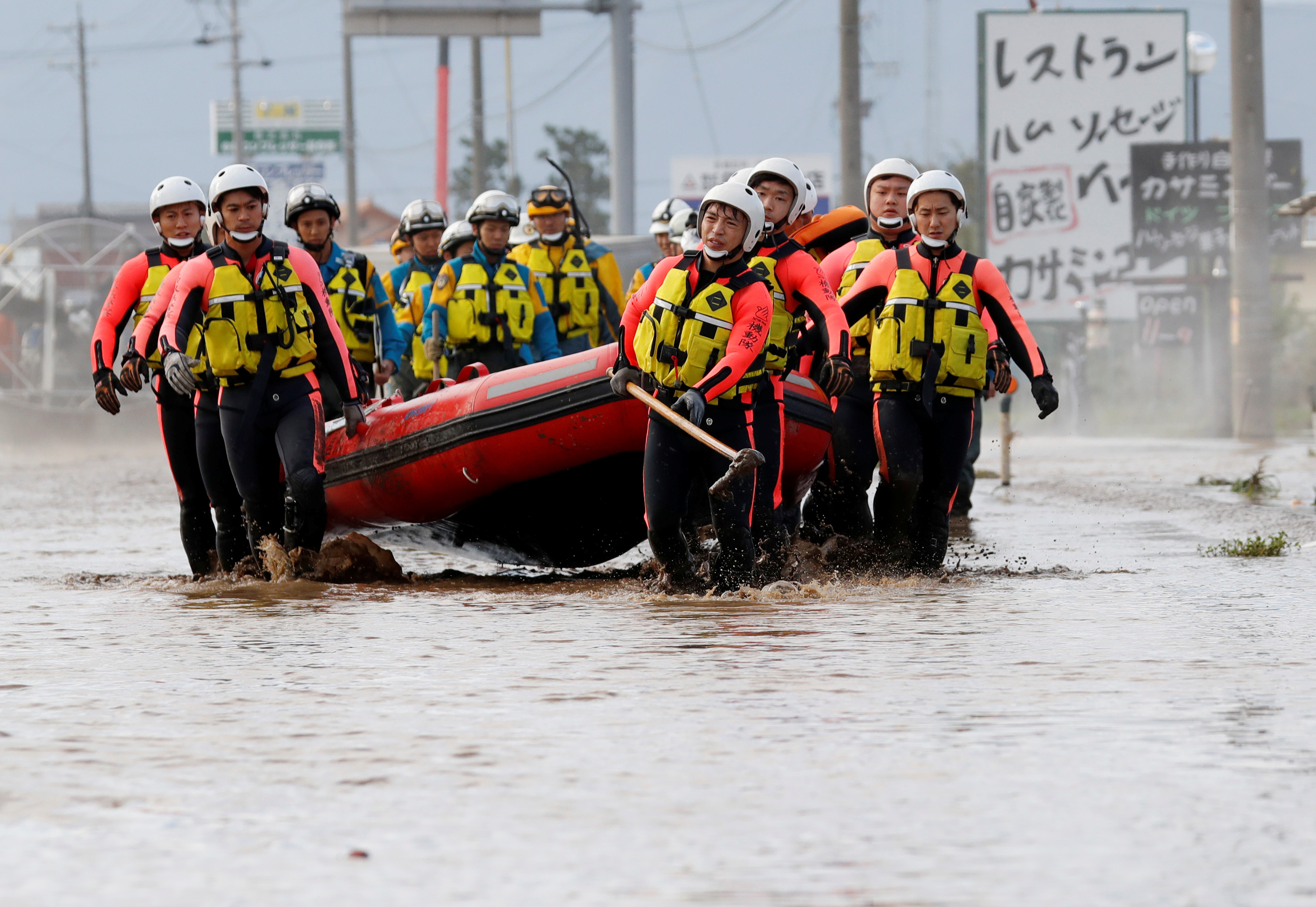 Japan rescuers wade in muddy waters to find typhoon survivors