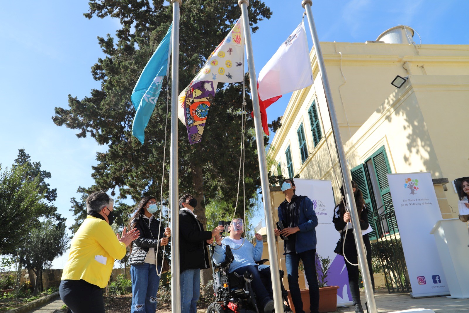 Interfaith children wave flag of unity and love - Newsbook